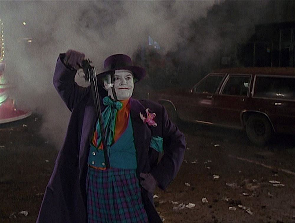 In Batman (1989), how was the Joker able to walk with that gun inside ...